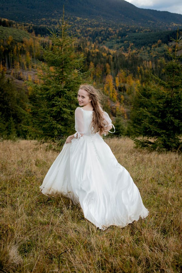 The Bride Runs Down the Hill and Lifts the Magnificent Dress Stock ...