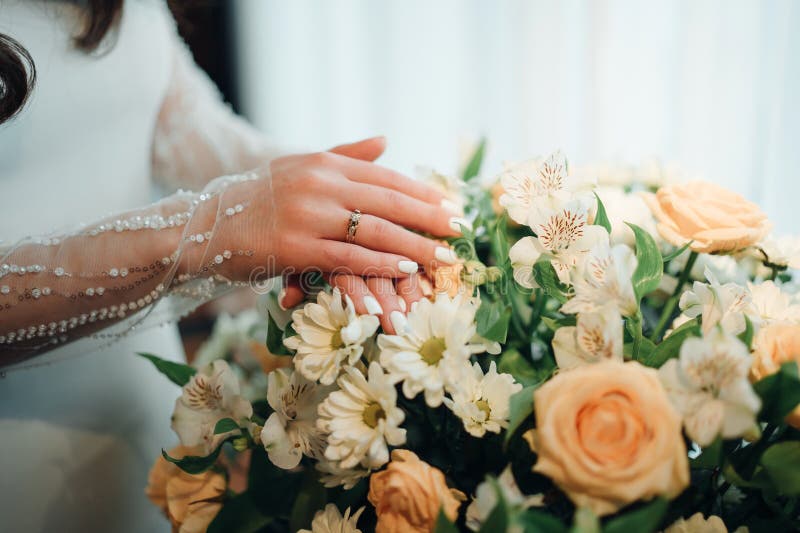 Bride S Hands with Wedding Ring on Bouquet. Stock Image - Image of ...