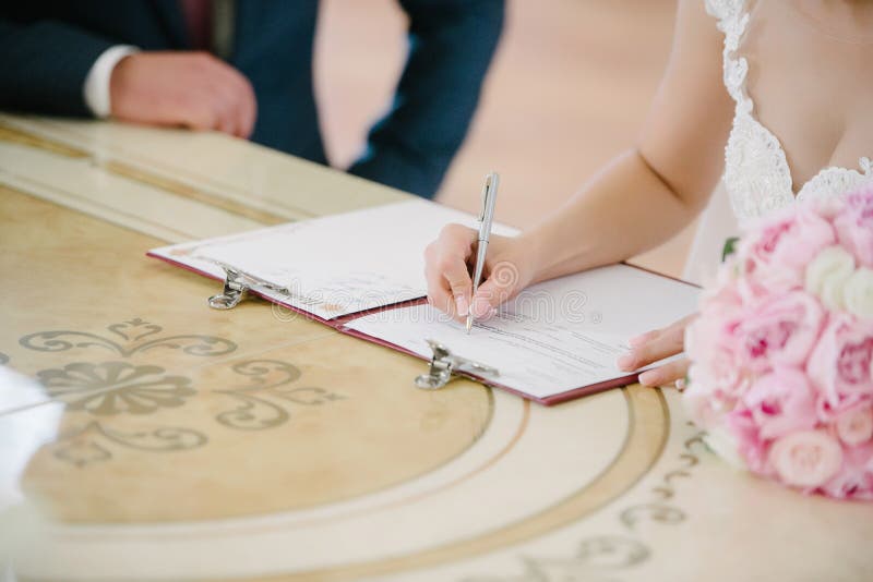 The Bride Signs on the Registration in the Document on the Wedding Day ...