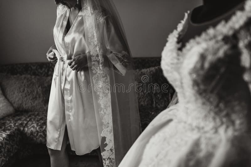 The Bride is Sitting on the Sofa in a Silk Dressing Gown. the Bride is ...