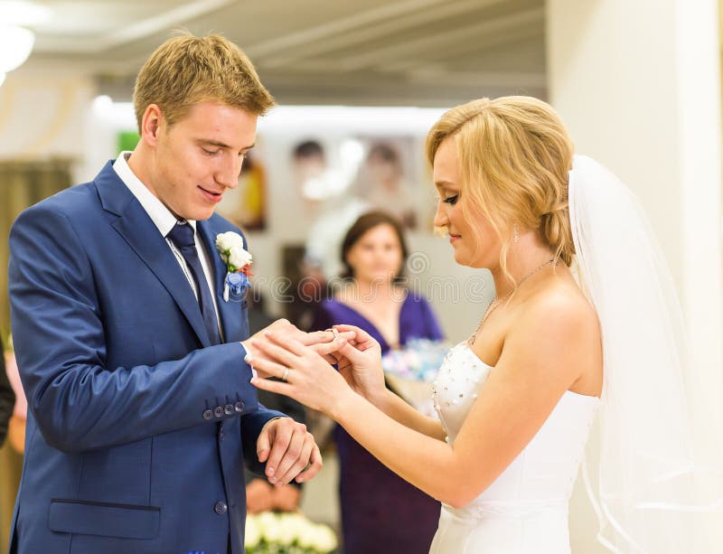Bride Slipping Ring on Finger of Groom at Wedding Stock Photo - Image ...