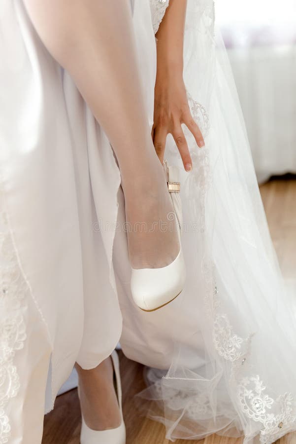 The Bride Standing on One Leg and the Second Leg Pulled a White Stock ...