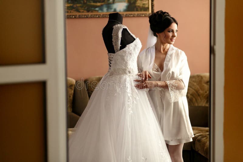 The Bride Stands Near Wedding Dress in the Room Stock Photo - Image of ...