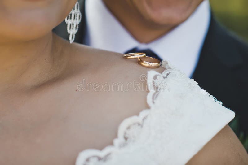 Wedding Rings on the Shoulder of the Bride . Stock Photo - Image of ...
