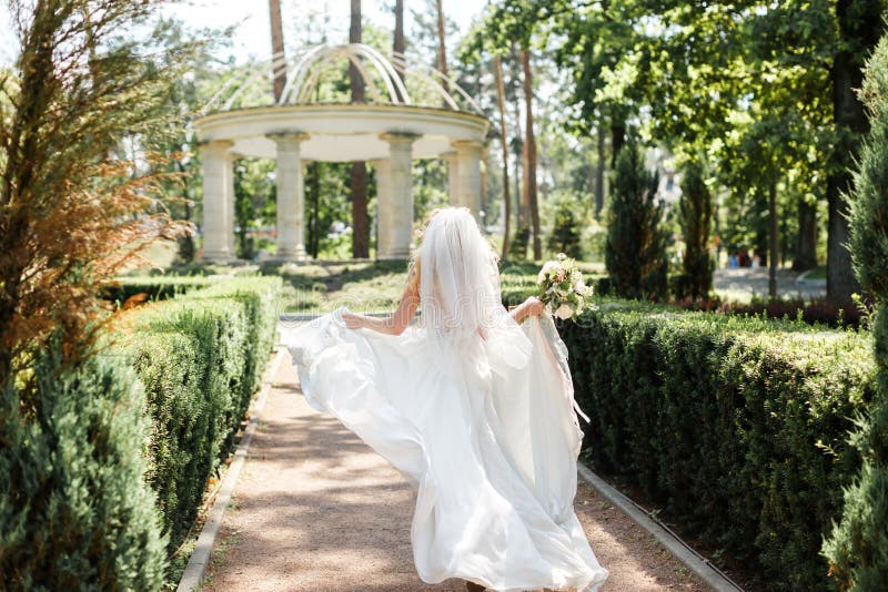 Bride in Wedding Dress Posing in the Garden Stock Photo - Image of ...