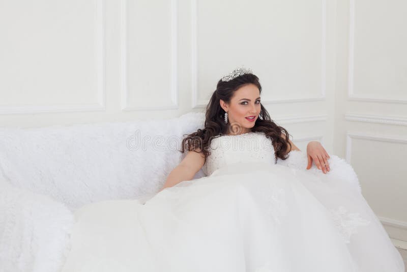 Bride in Wedding Dress Sitting on the Couch Stock Photo - Image of ...