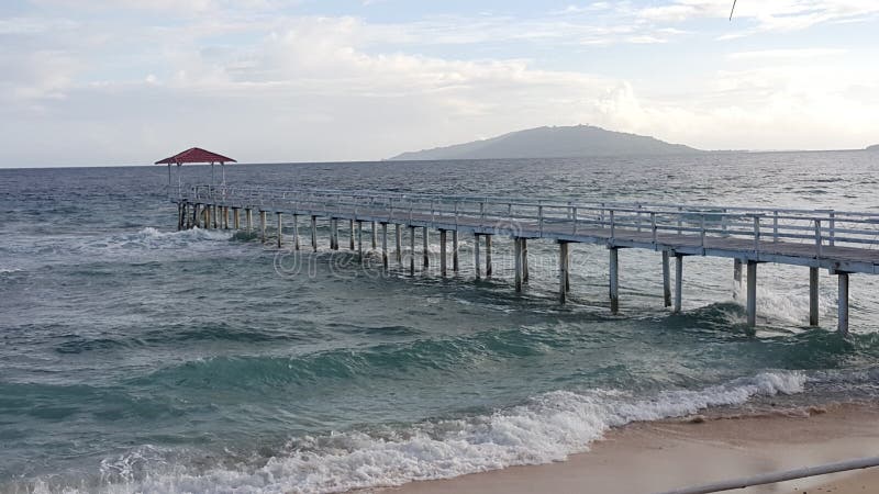Bridge in the beach stock photo. Image of sunset, clouds - 82319104