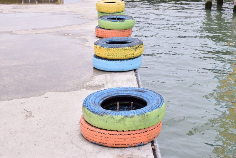 A Bridge of Car Tires Across a Stream among Green Grass. Waste ...