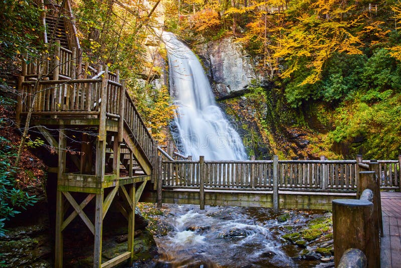 Bridge Boardwalk Crosses River in Front of Huge Waterfall Over Cliffs ...