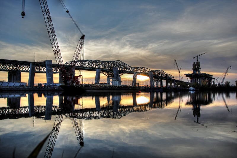 Bridge Construction at Sunset with Water Reflection Stock Image - Image ...