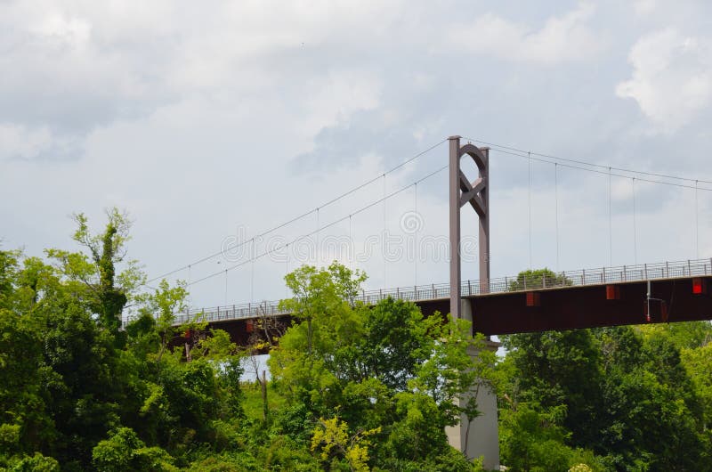 Bridge Extending Over Tree Lined River Stock Photo - Image of trees ...