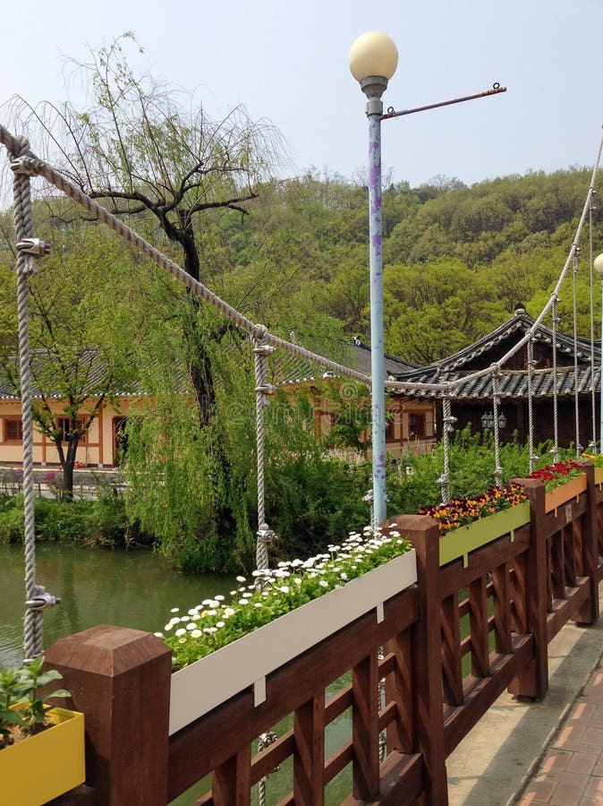 Bridge with Flowers Across the River Stock Image - Image of house ...