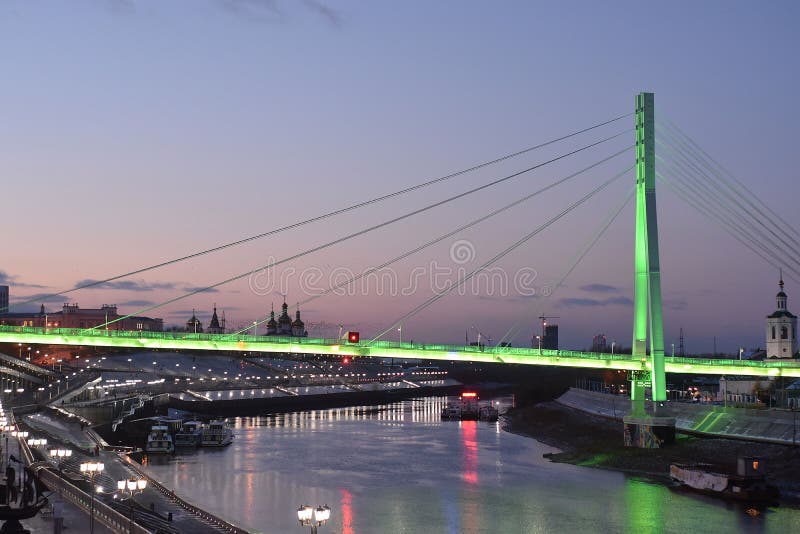 The Bridge Glows at Night and is Reflected in the Water Stock Image ...