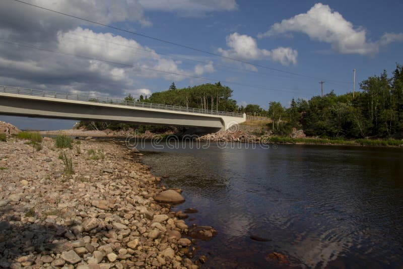 A Bridge Going Over a River with Forest on the Right Hand Side Stock ...