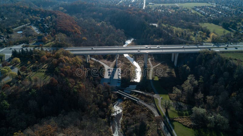 A Bridge Going Over a Valley and River Stock Photo - Image of treetop ...