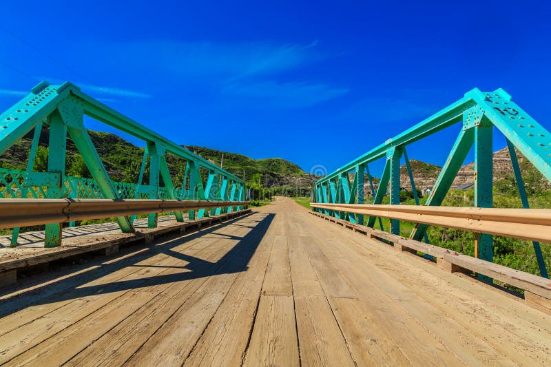 A Bridge with a Green Railing and a Blue Sky in the Background Stock ...