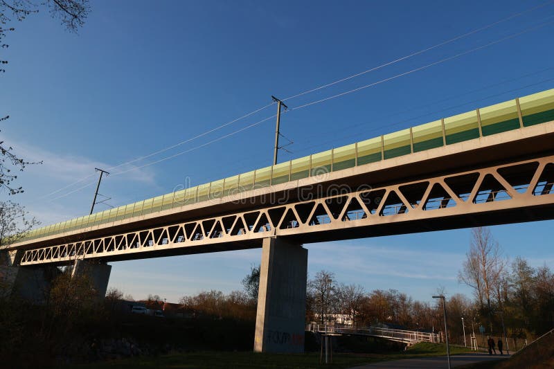 A Bridge with a Green Railing and a Train Crossing it Stock Image ...