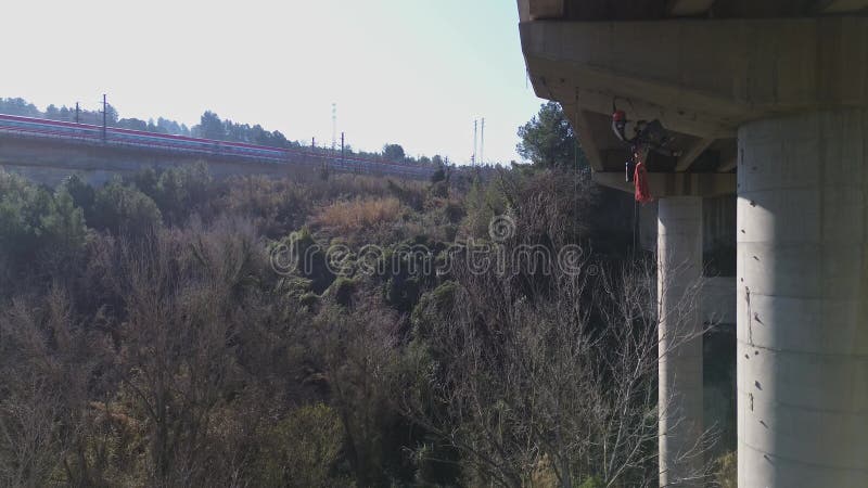Bridge Inspection and Maintenance: Technician Working Underneath Stock ...