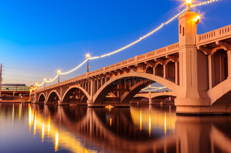 A Bridge with Lights on it and a Reflection of the Lights in the Water ...