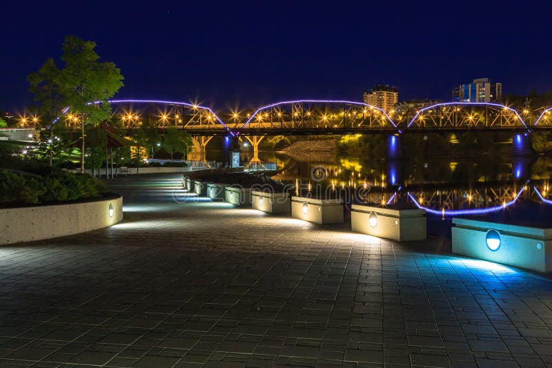 A Bridge is Lit Up at Night, with Lights Reflecting on the Water Stock ...