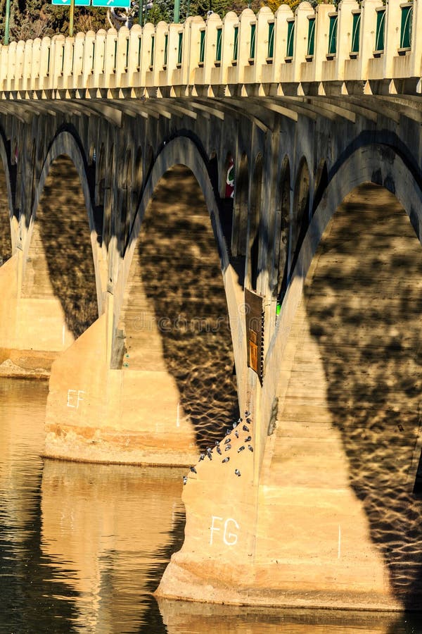 The Bridge is Made of Concrete and Has a Green Railing Stock Image ...