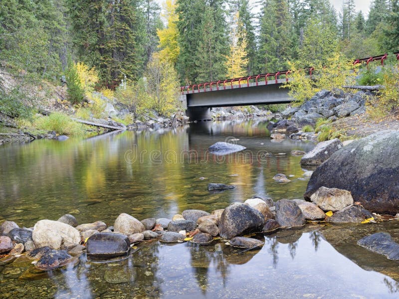 Bridge Over a Calm Rock Lined Stream Stock Image - Image of colorful ...