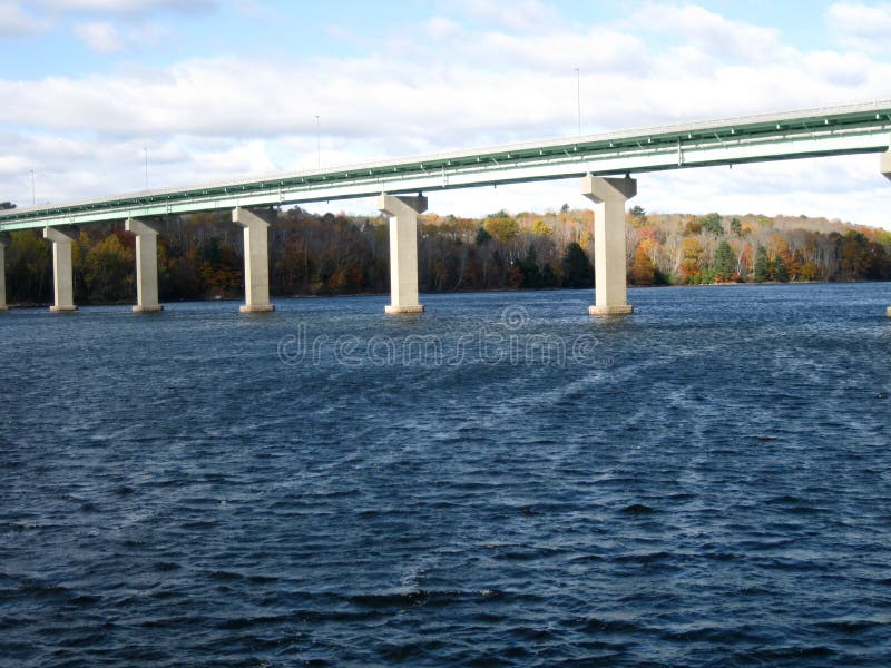 Bridge Over Large Body of Water Stock Image - Image of leaves, lake ...