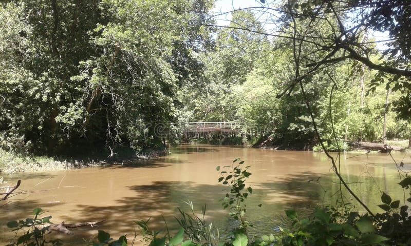 Bridge over muddy water stock image. Image of water - 147366327