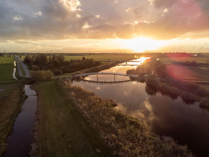 Bridge Over a River with Its Image Reflecting in the Water, in a Green ...