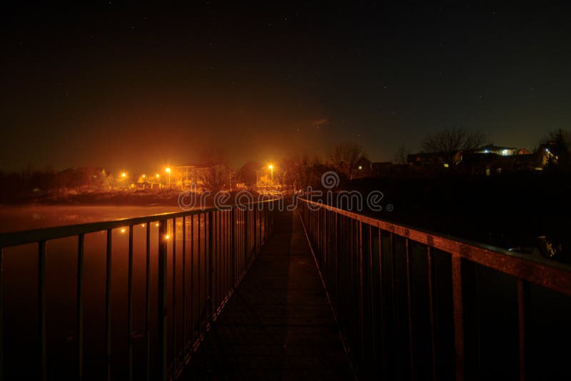 Bridge Over the River in the Red Glow Against the Starry Sky Stock ...