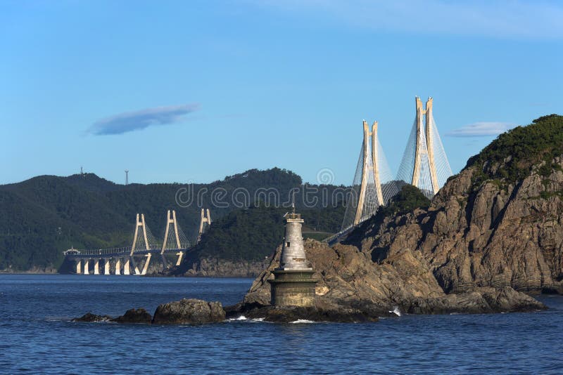 Cable-stayed Bridge To the Island with a Lighthouse on the Rocks Stock ...