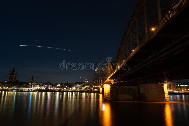 A Bridge Over Water at Night with Some Lights on the Side Stock Image ...