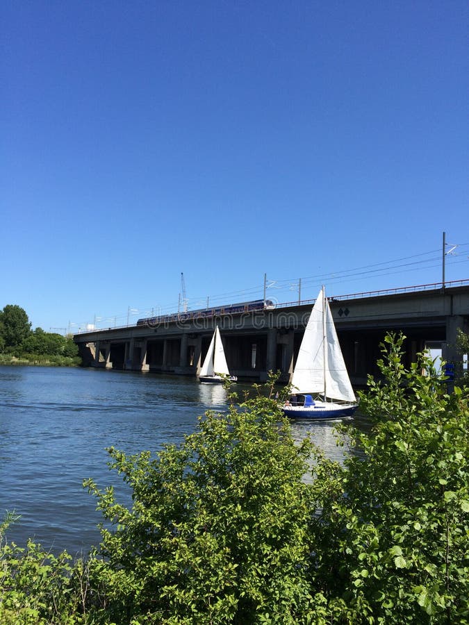 Bridge Over Water with Train and Boats Passing Under the Bridge Stock ...