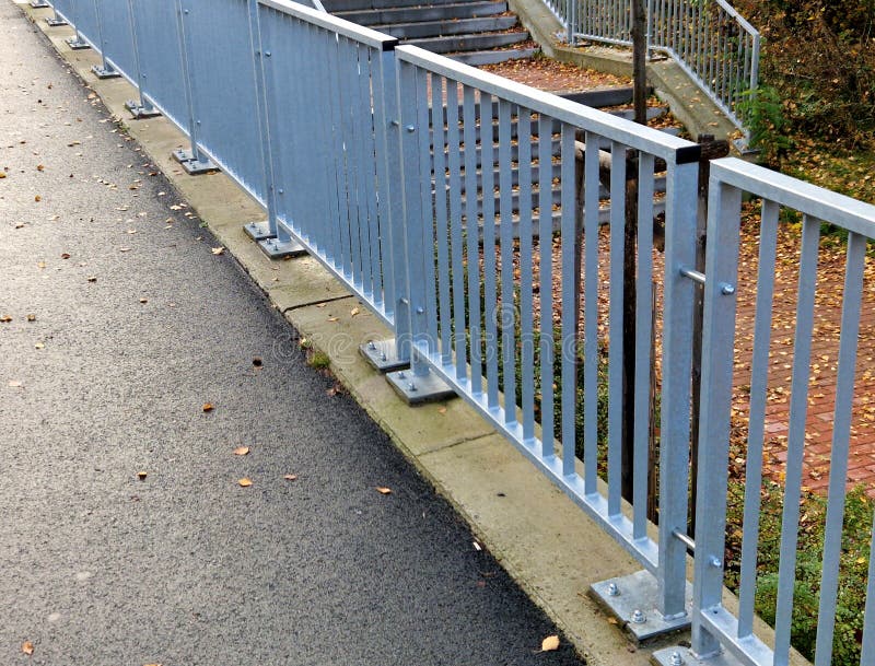 Bridge Railing with Vertical Fence Posts Anchored into the Ground Stock ...