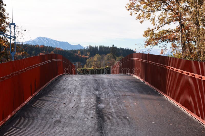 A Bridge with a Red Railing and a View of the Mountains Stock Photo ...