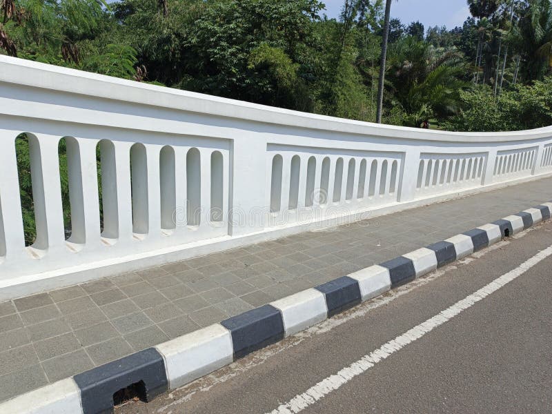 Tranquil Roadside View with Railing and Greenery Stock Image - Image of ...