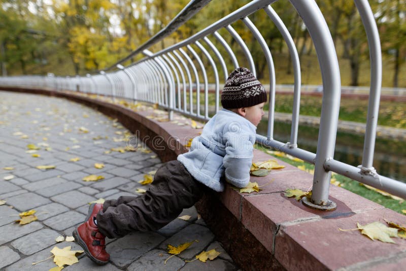 On the Bridge a Small Child Looks Down from the Bridge Stock Photo ...