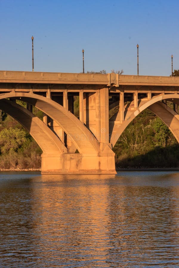 A Bridge Spans a River with a Calm, Reflective Water Surface Stock ...