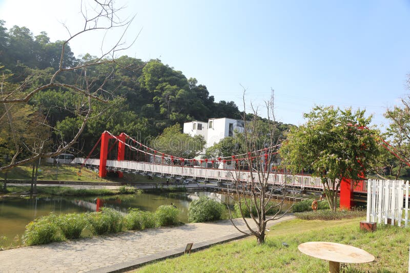 A Bridge Spans a River in a Park Stock Photo - Image of nature, park ...