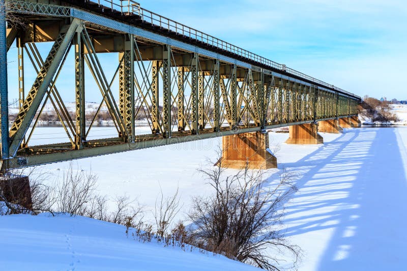 A Bridge Spans a River with Snow on the Ground Stock Photo - Image of ...