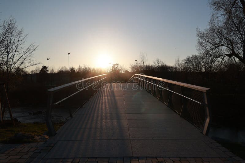A Bridge with a Sun Shining on it Stock Photo - Image of scenic, clouds ...
