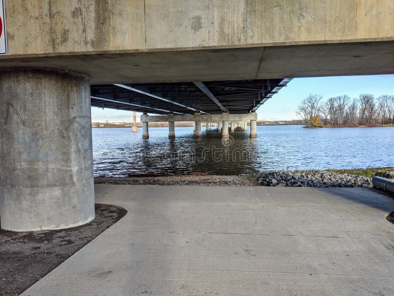 A Bridge from Underneath Reflected in Water. a Dividing Line between ...