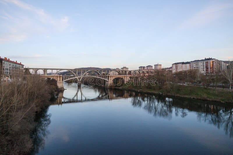 Bridges Going Over the River Surrounded by Buildings Stock Photo ...