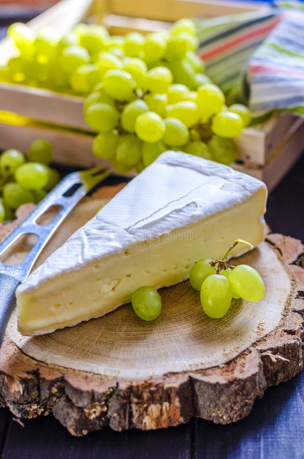 Brie cheese and grapes stock image. Image of slice, peel - 175234143