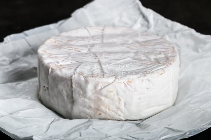 Brie Cheese Lies on the Wrapping Paper on the Table Stock Image - Image ...