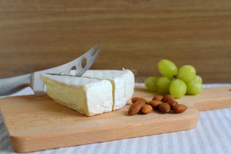 Brie Cheese in Wooden Plate Stock Photo - Image of breakfast, fresh ...