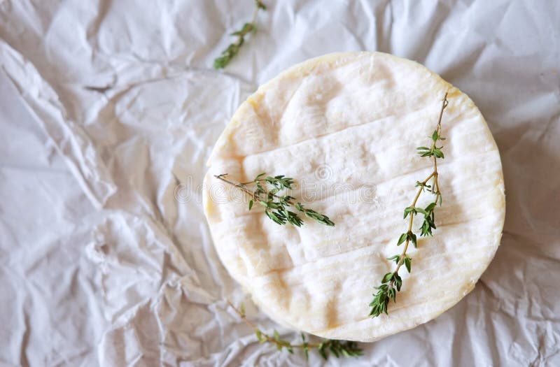 Brie Cheese on Wrapping Paper with Thyme Herbs Stock Photo - Image of ...