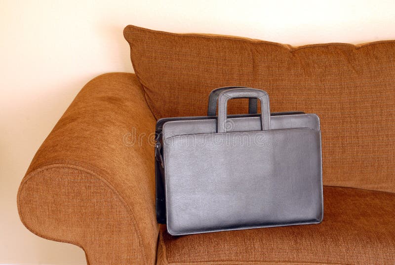 Briefcase on a sofa stock image. Image of portfolio, couch - 7521153