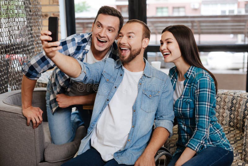 Bright Admirable Guy Enjoying Fun Time with His Friends Stock Photo ...