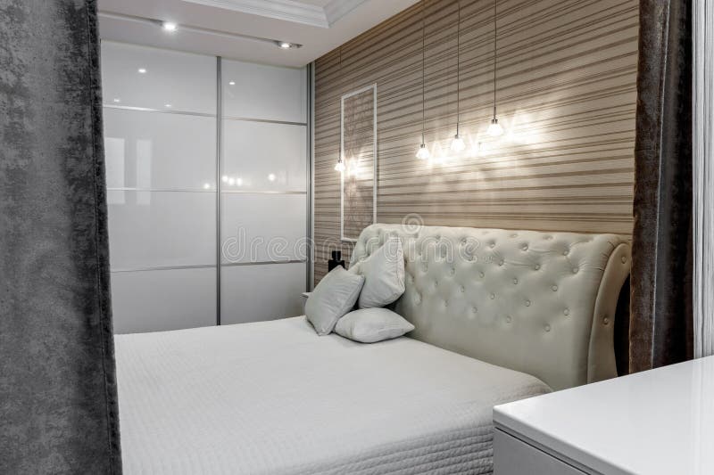 Bright Bedroom with Large White Bed and Capitone Headboard Stock Photo ...